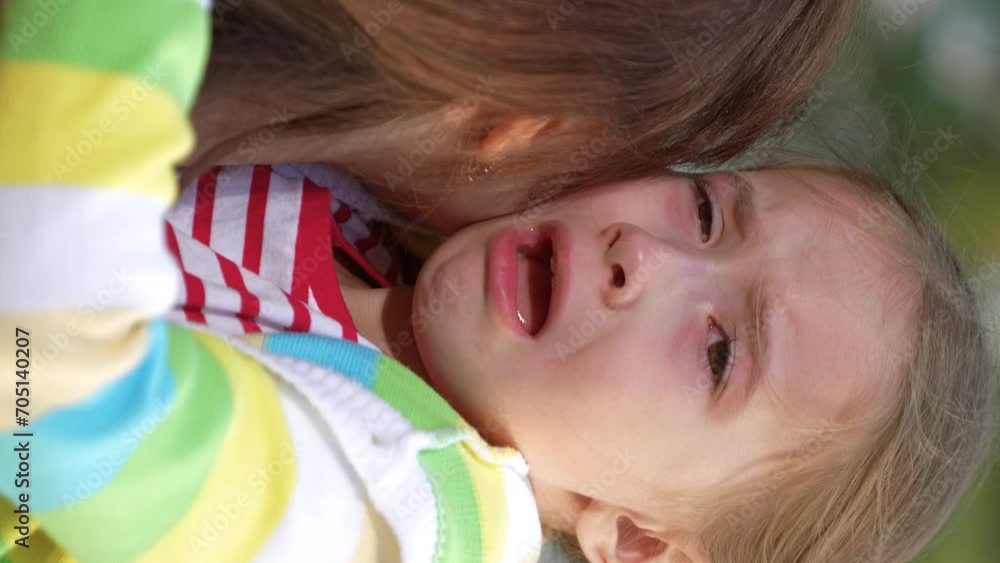 little child cries, tears child face, mother calms capricious kid girl ...