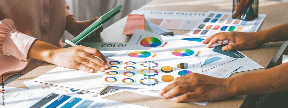 Skilled architect searching data from tablet while selecting an ...