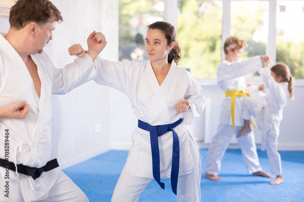 Parent with child partners during martial arts karate class train to ...