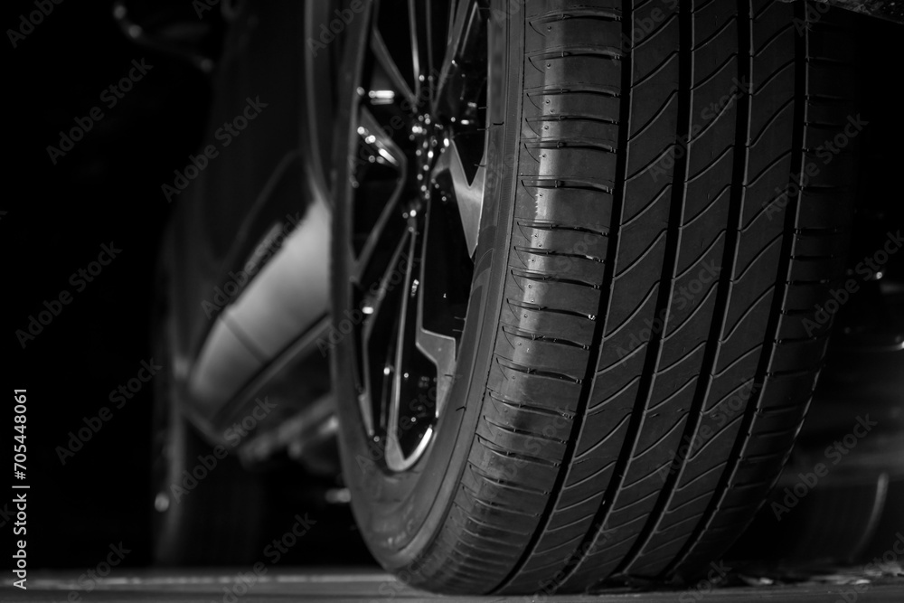 Low angle, back, rear view of a car, vehicle and its tires at the ...