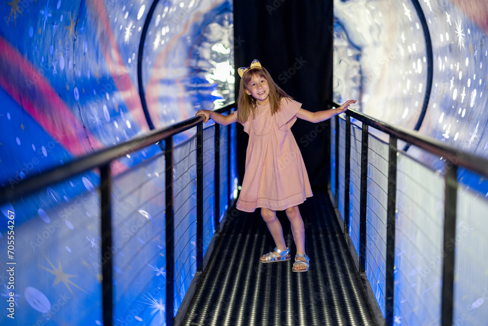 Little girl in a room that shows the universe and gravity, visiting ...