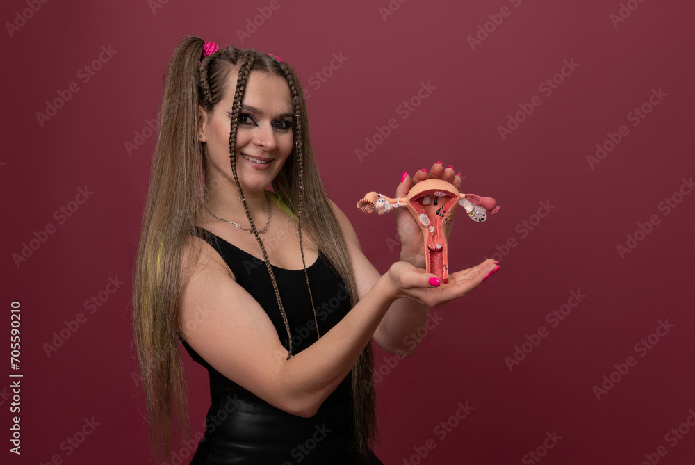 woman holds model of female reproductive system in the hands. Help and ...