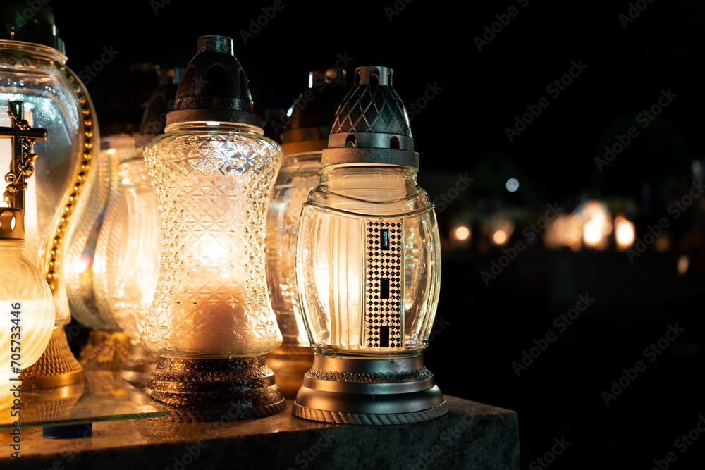 Cemetery grave candle glass lanterns, znicz illuminated at night. Memorial light remembrance ...