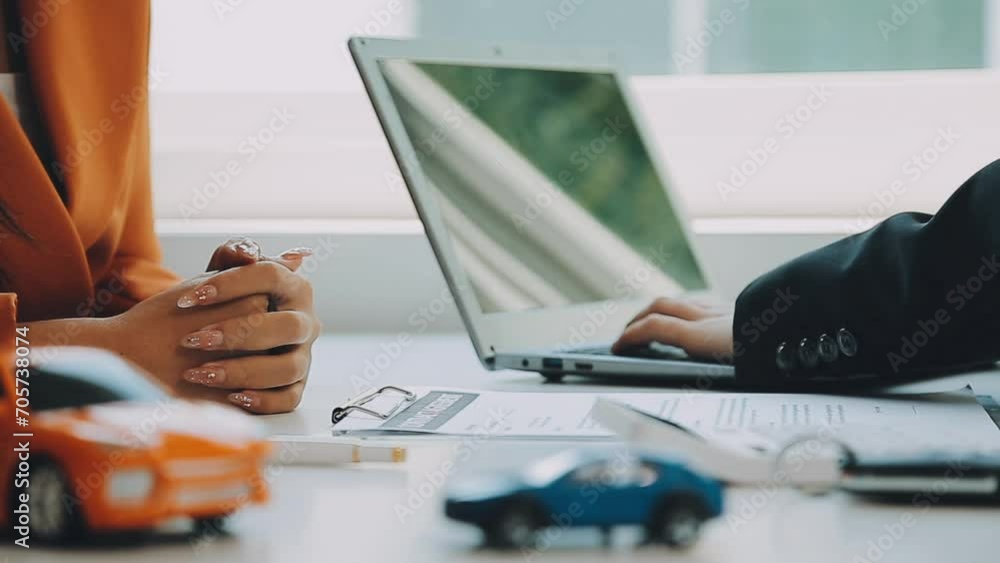 Salesman guiding customer seated at table. Car business. Car sale ...