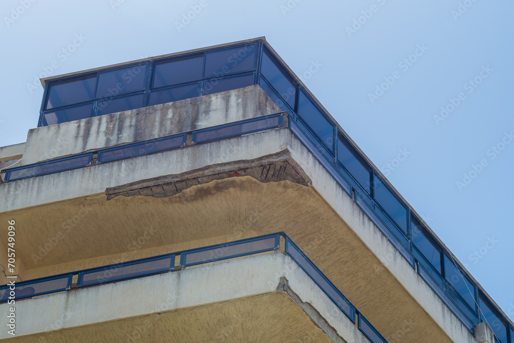 Collapsing corners of ceiling with exposed metal fittings and falling ...