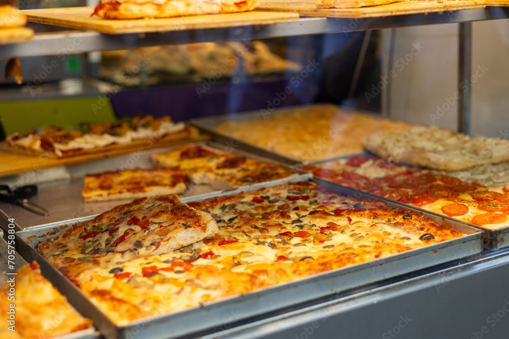 Authentic Italian pizza in a restaurant display window. Various ...
