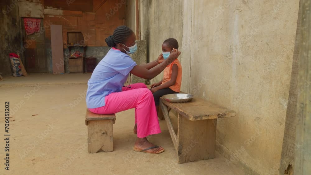 doctor nurse wearing a mask to a children of africa in remote village ...