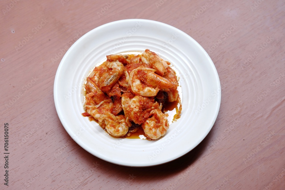 Schezwan Prawns in white plate with wooden background. Schezwan Prawns ...