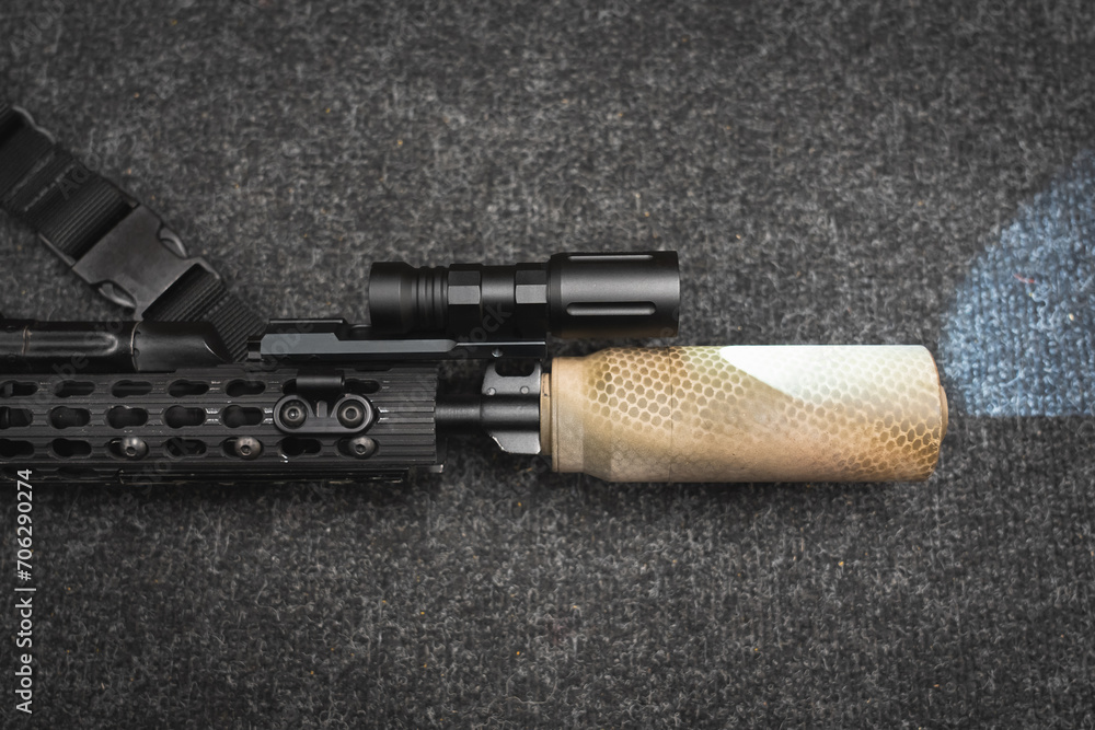 Tactical weapon, rifle with silencer and flashlight, close-up photo ...