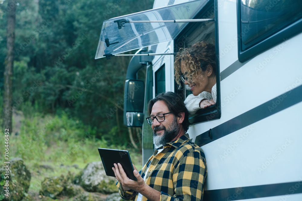 Happy adult couple enjoy travel destination with motorhome camper van ...