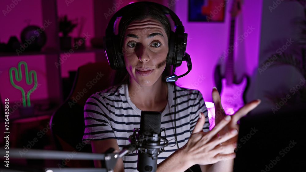 Confident young hispanic woman gamer dominating digital entertainment ...
