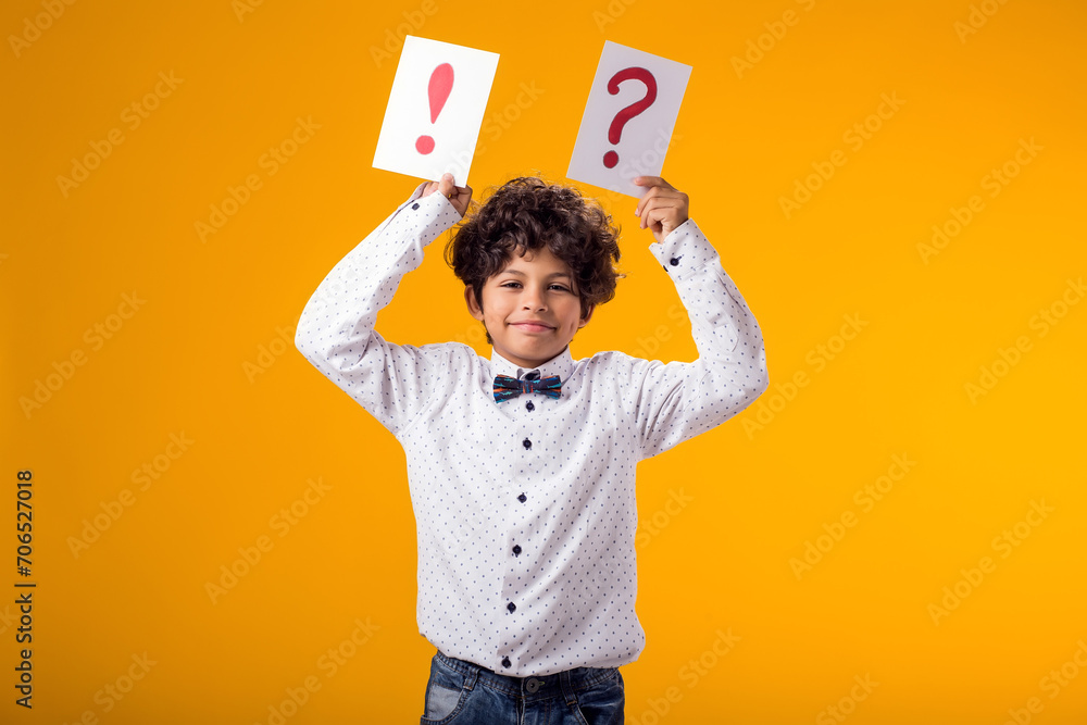 Child boy holding question mark and exclamation point cards ...