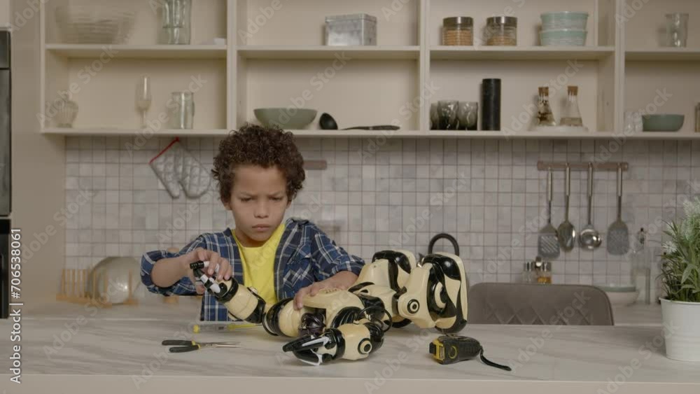 Skillful concentrated smart cute preadolescent boy, fixing broken toy ...