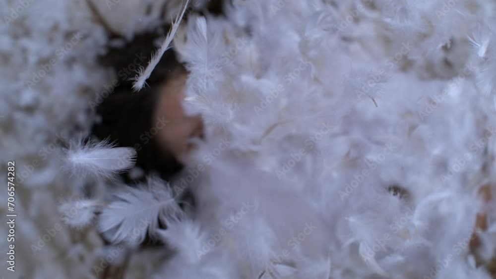 Little Girl Lying in Feather Bed, Carefree and Joyful. plumage falling ...