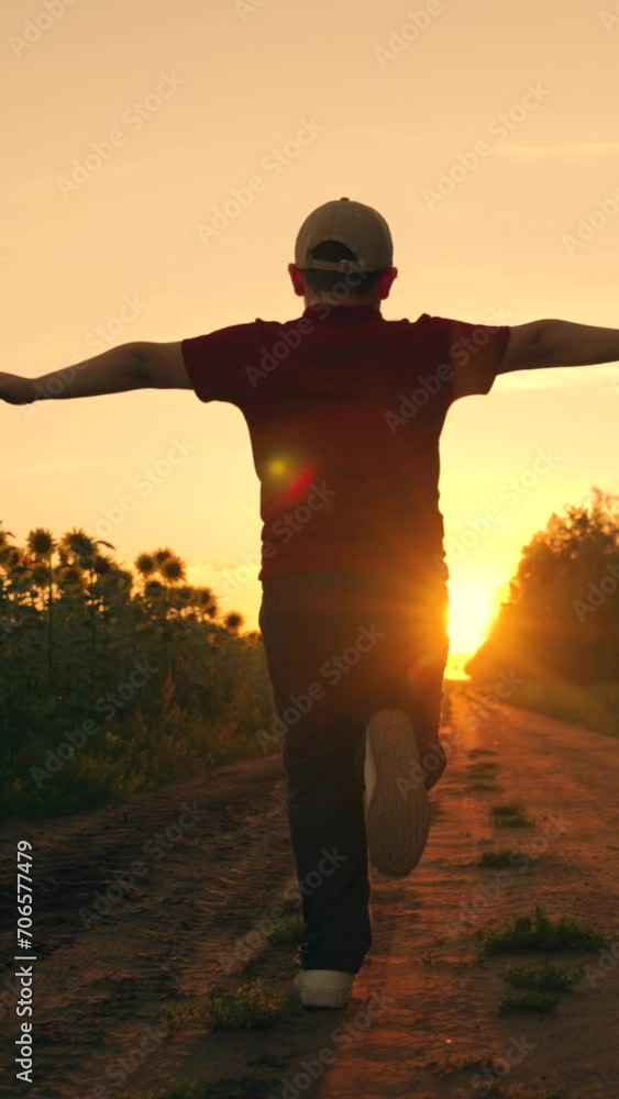 Child runs with his arms raised like wings of an airplane, childhood ...