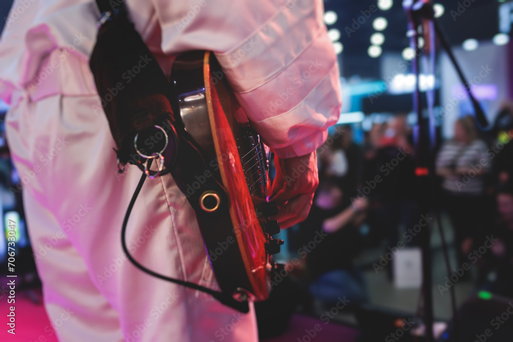 Concert view of an electric guitar player with vocalist and rock band ...