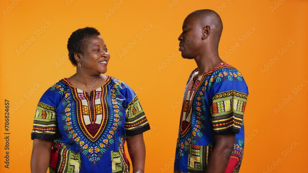 Cool african american couple greeting with fist bump in studio, saying ...