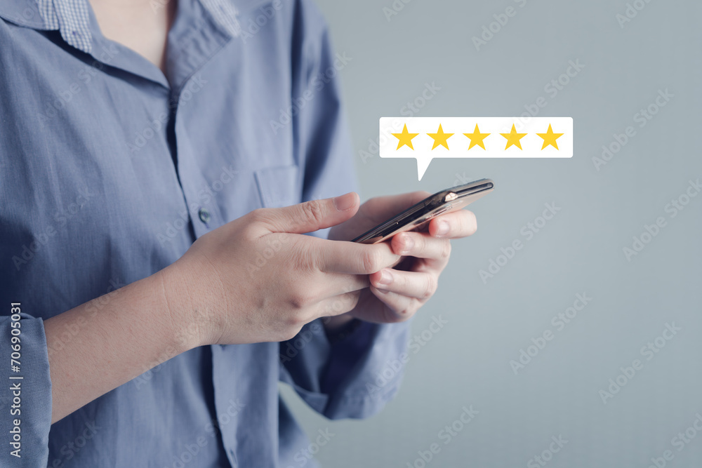 Customer using mobile smartphone for giving satisfaction score with ...