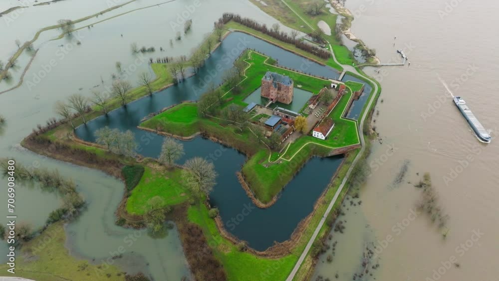 Overflown banks of river Waal caused flooding around Loevestein castle ...