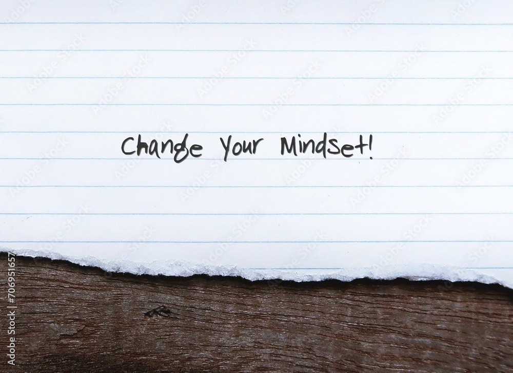 Paper on wood background with handwritten text CHANGE YOUR MINDSET , to ...