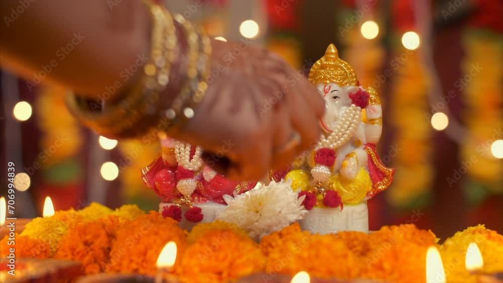 Indian woman offering flower to goddess Lakshmi and Lord Ganesh ...