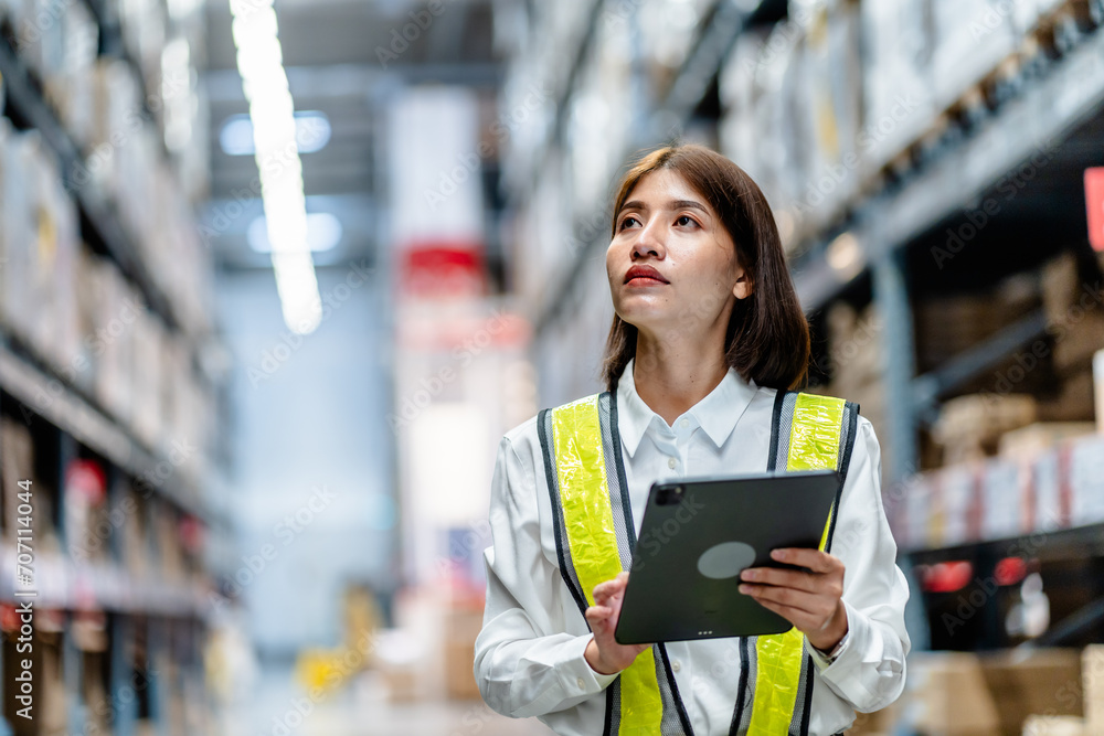 Women warehouse worker using digital tablets to check the stock ...