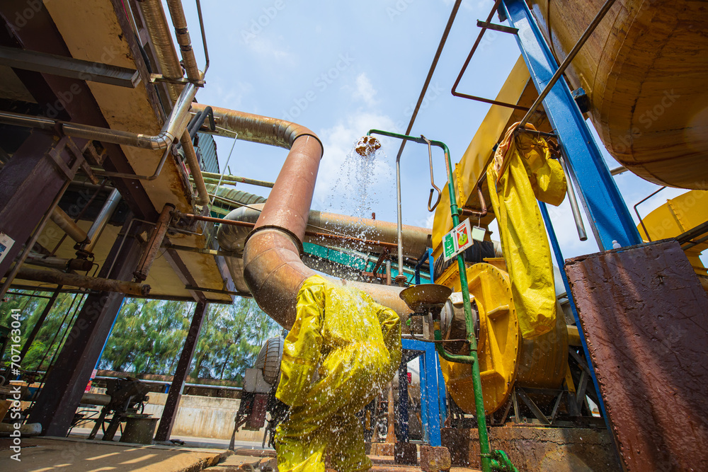 Male workers dressing in protective shower detoxification suit clean up ...