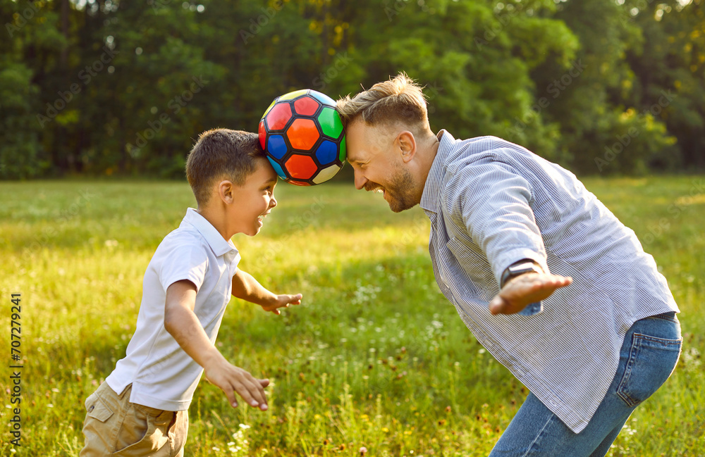 Father and son playing with ball in summer. Parent and child having fun ...