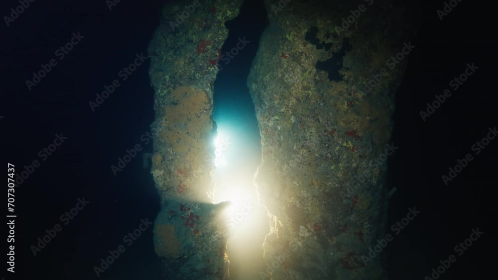 Cave freediving. Freediver swims underwater and explores intricate ...