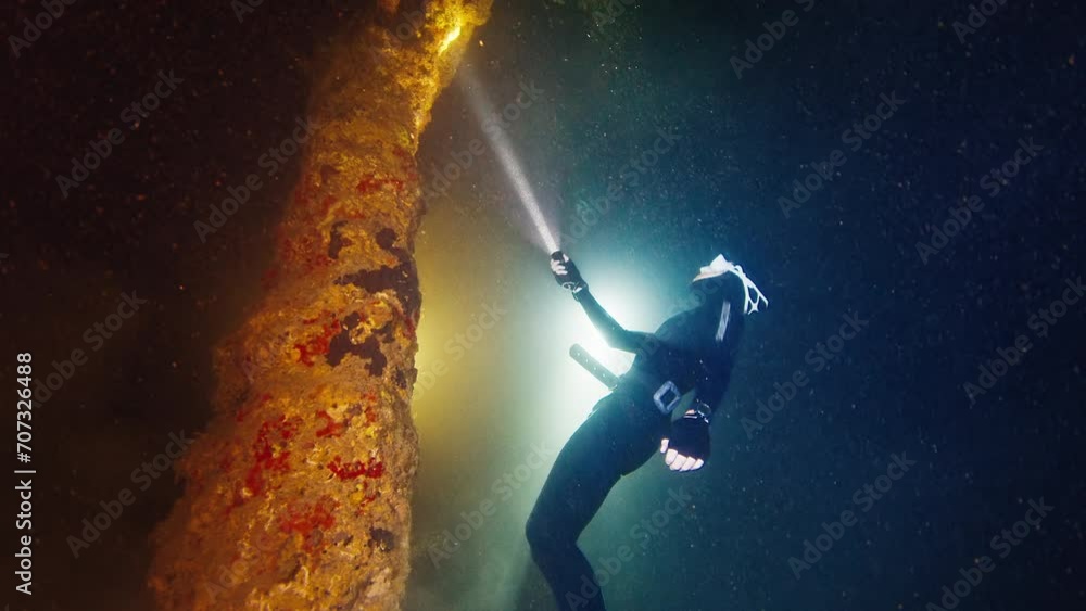 Cave freediving. Freediver swims underwater and explores intricate ...