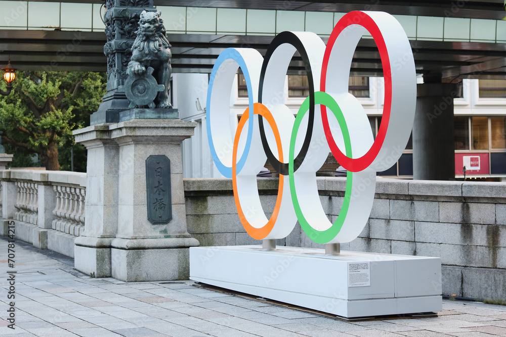 TOKYO, JAPAN - July 28, 2021: An Olympic Ring monument and statue of a ...