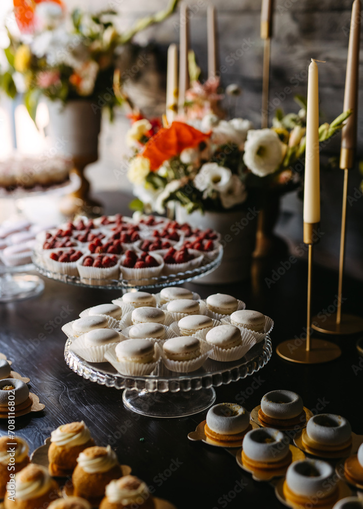 Dessert table at an event with macarons and tarts. Candy bar at a ...