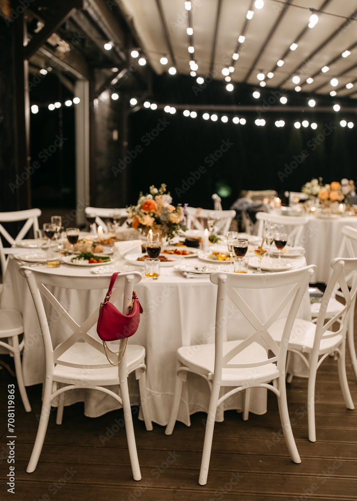 Cozy wedding reception dinner under festoon lights. Stock Photo | Adobe ...