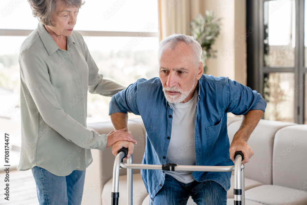 Old senior wife grandmother helping aiding supporting with walking and ...