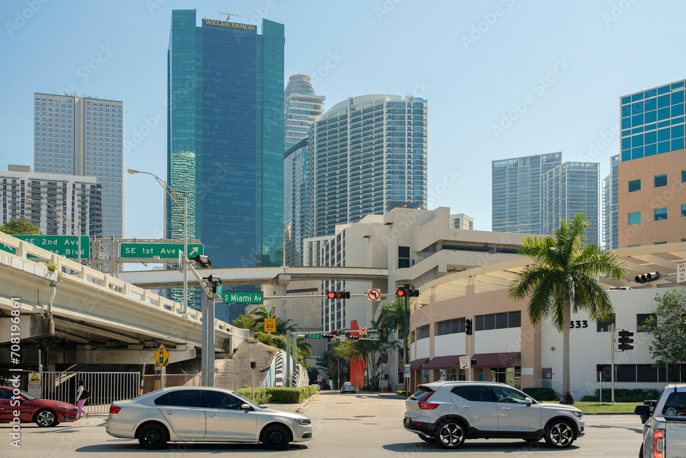 Miami street traffic with driving cars at urban intersection with ...