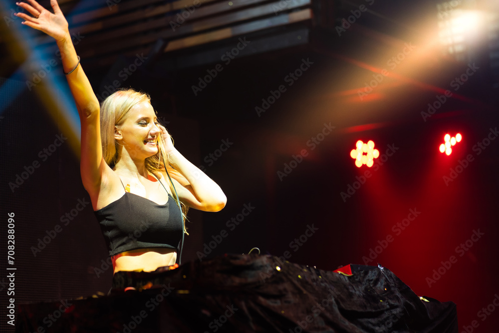 Caucasian female DJ with Turntables at nightclub. Group of diverse ...