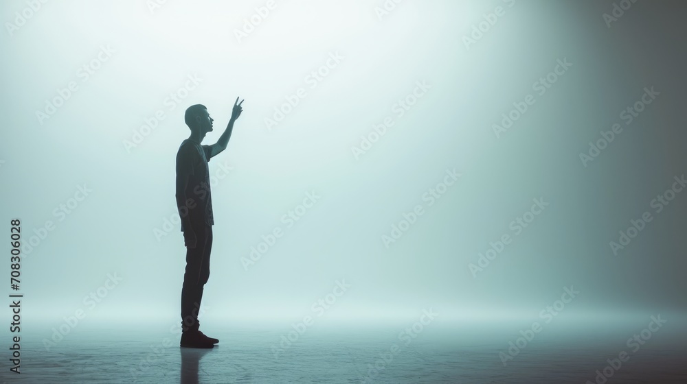 silhouette of a person looking right and pointing up with a left hand ...