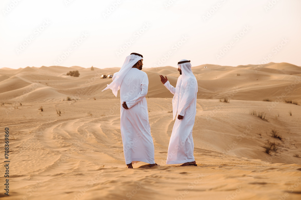 Poster Two business men wearing traditional uae white kandura spending ...