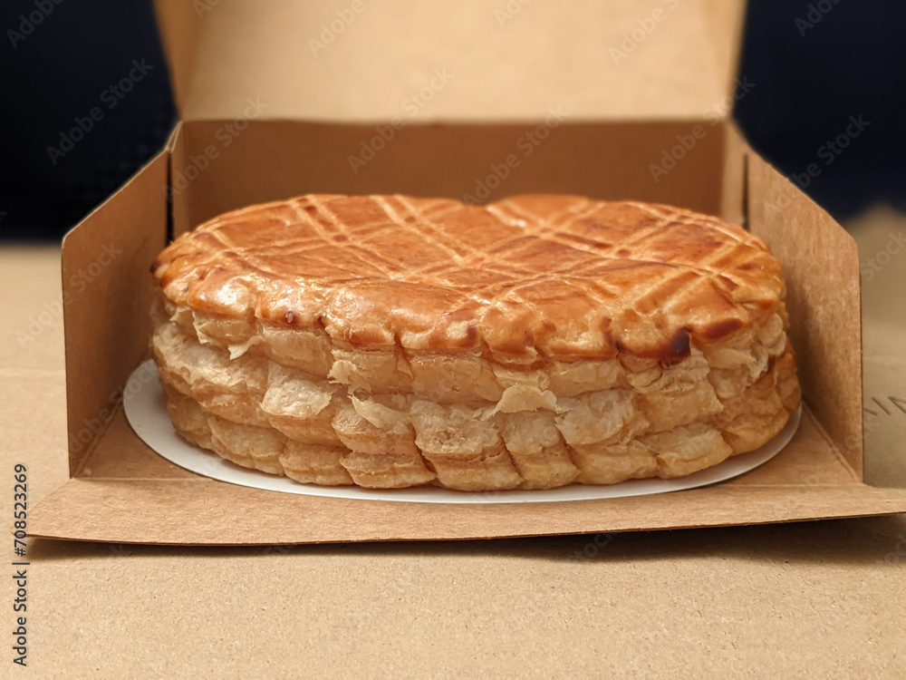 A traditional fluffy French galette des rois or king cake in its ...