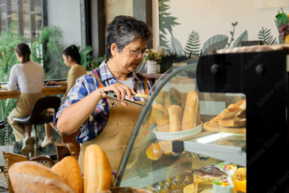 Asian 60s healthy senior waitress worker woman or bakery shop small ...