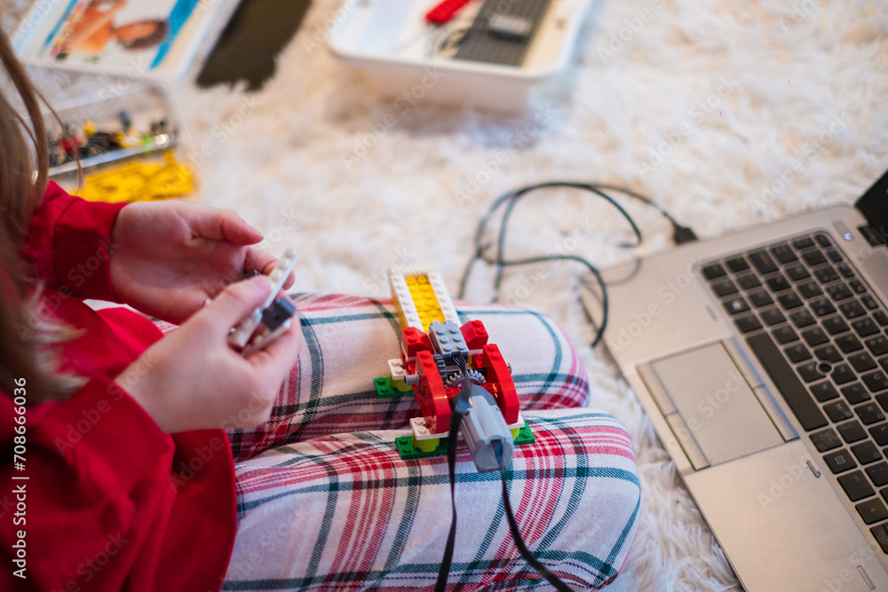 Tallinn, Estonia - December 25, 2023: Child building a moving Lego ...