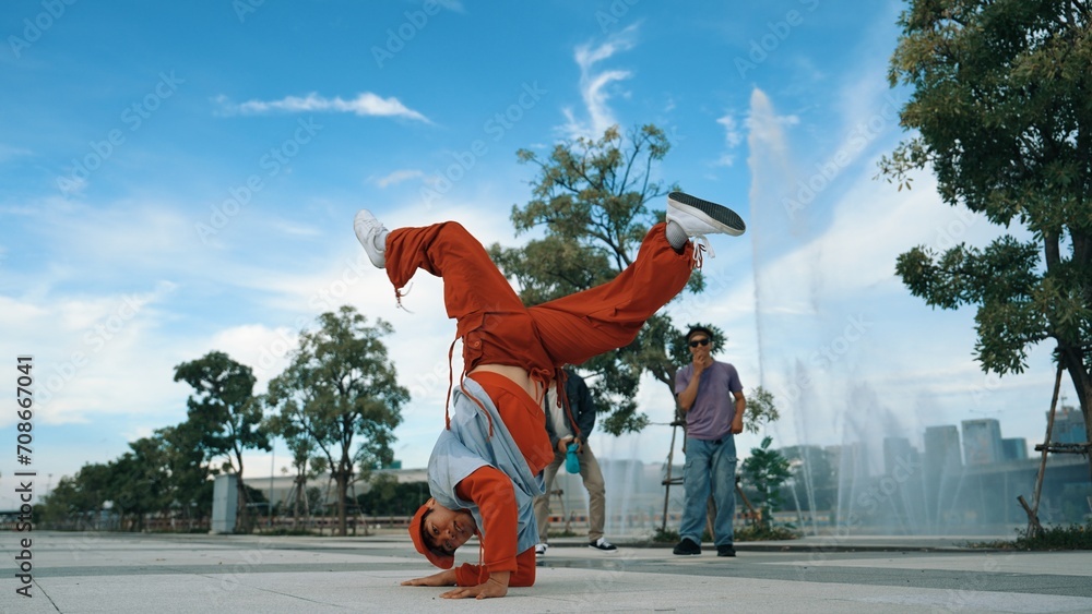 Asian skilled hipster doing freeze pose at camera surrounded by break ...