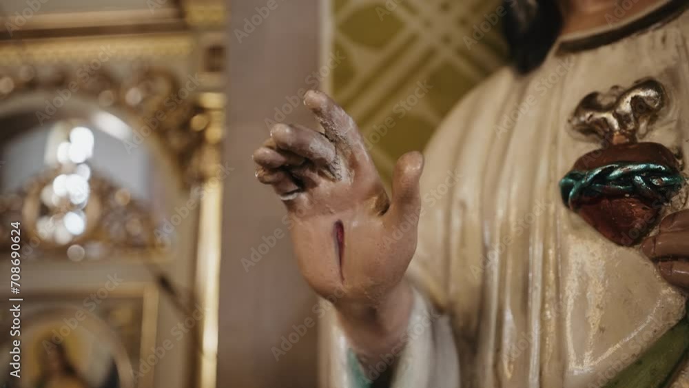 Close-up of a religious statue's hand with stigmata and a sacred heart ...