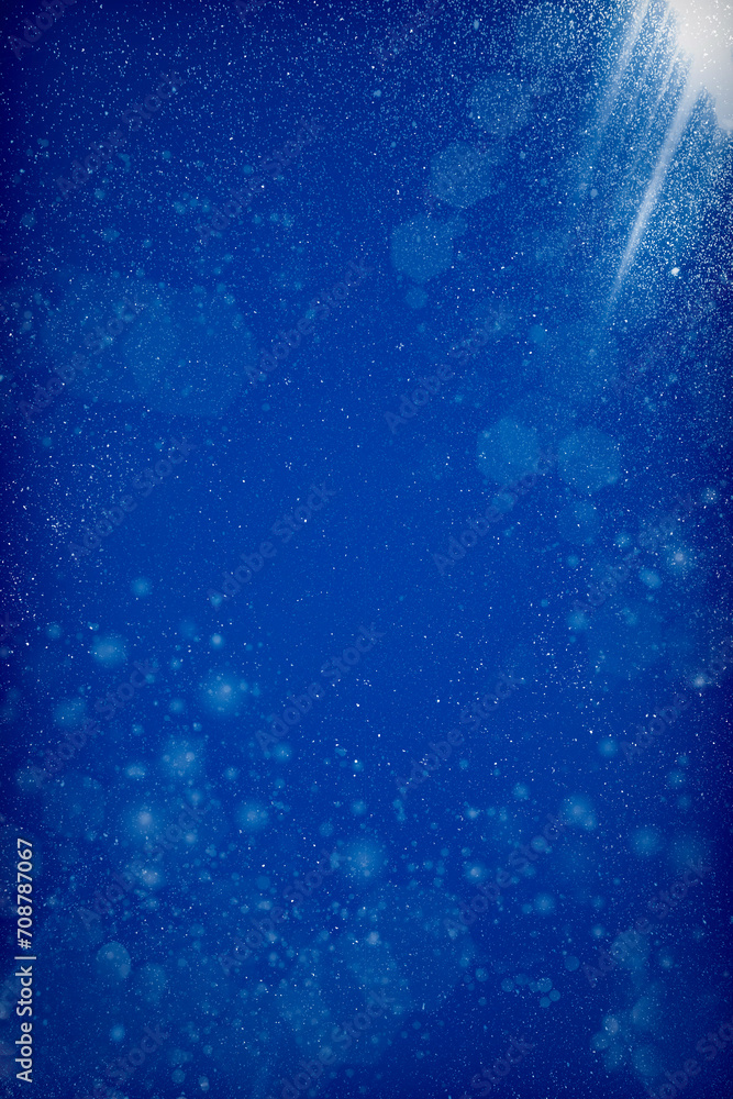 Floating dust particles on a vibrant blue background. White dust ...