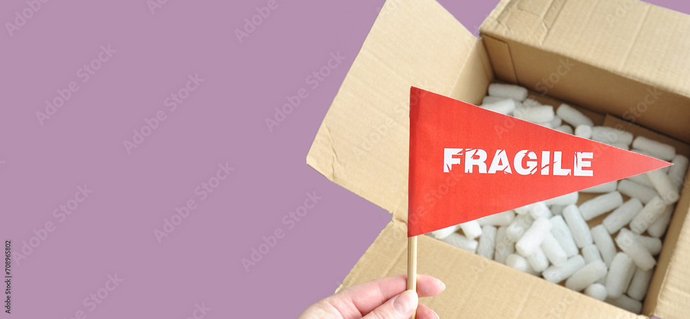 Opened cardboard packaging box with white polystyrene packaging chips ...