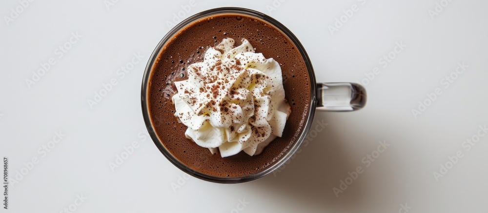 Top view of a white background with a glass cup of tasty hot chocolate ...