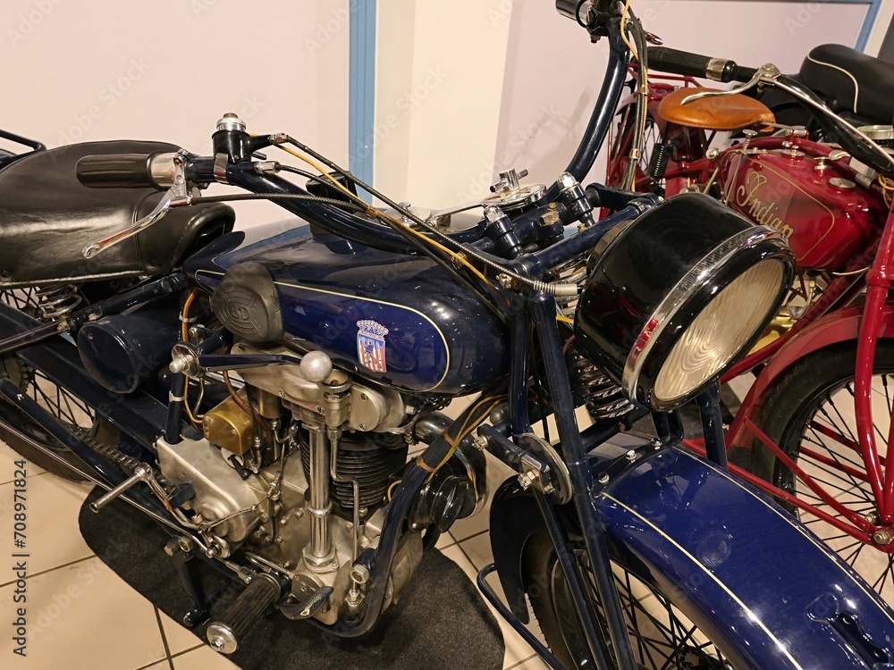 Front view of handlebars, round headlight, bumper, fuel tank and engine ...