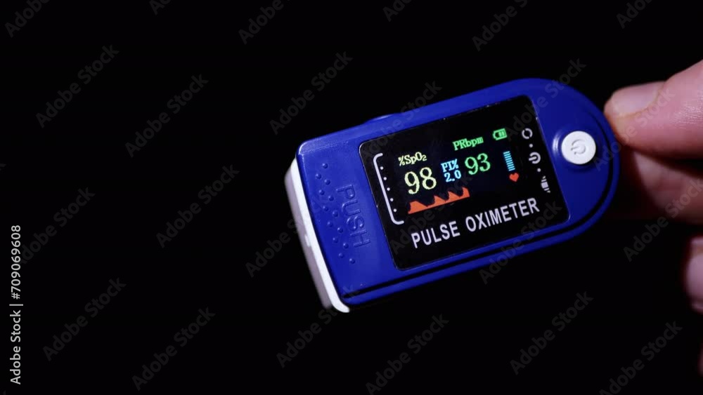 Woman Measures Pulse and Oxygen Saturation Using a Pulse Oximeter at ...