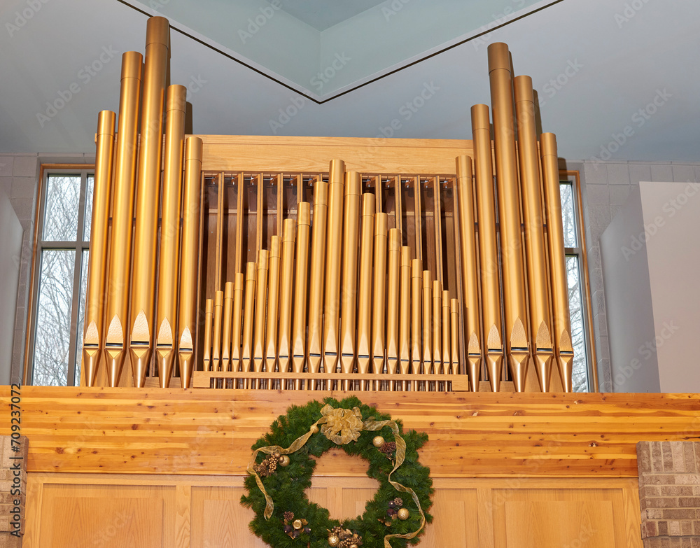 Catholic Church. Pipes of pipe organ in church sanctuary. Above alter ...