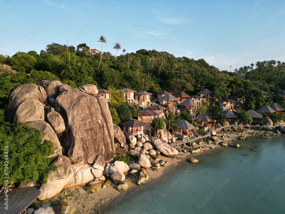 Drone photo of rocks and houses at Taa Toh Lagoon Beach in sunset ...